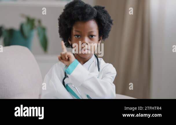 Portrait little serious kid girl in medical gown pretending be doctor ...