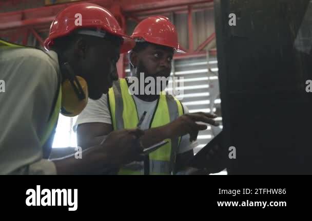 Engineer two worker man African black marking inspection on roll metal ...