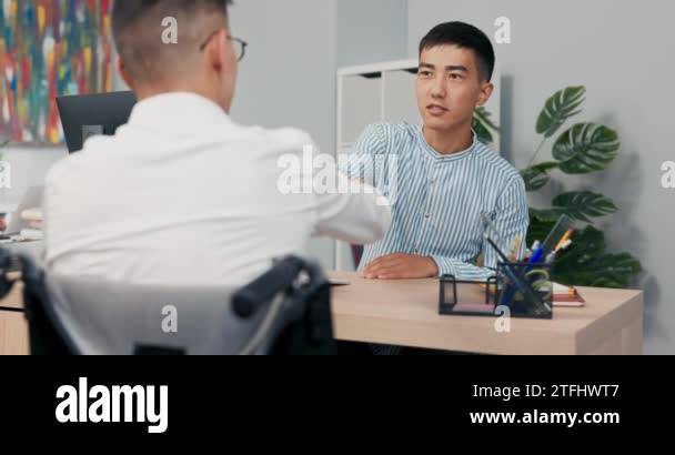 Two men meet in company office morning for interview disabled boy ...