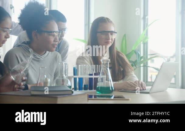 Young teacher teaching group student about science and explaining ...