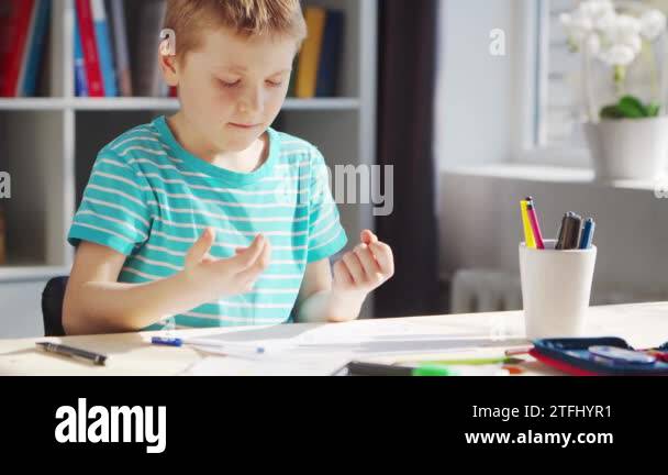 Boy is Doing his Homework at the Table. Cute Child is Learning at Home ...