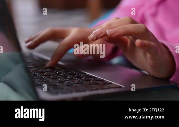 Close-up teen female fingers typing fast on laptop keyboard ...