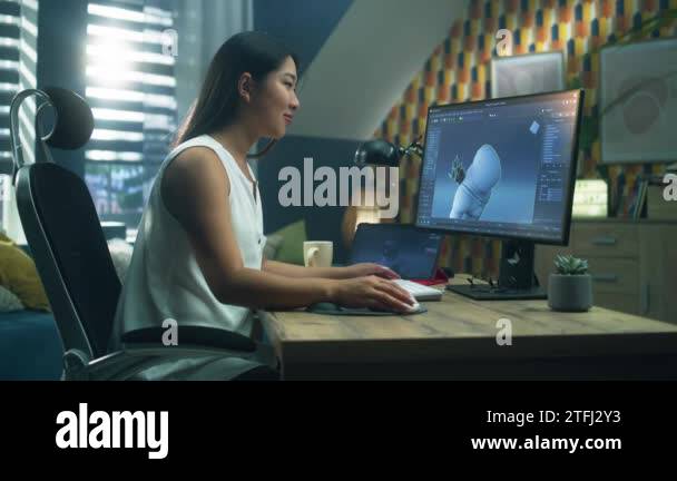 Asian woman creating 3D model of video game character in professional ...