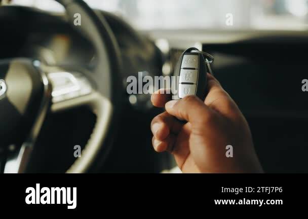 Close up of man holding contactless car key in hand and winding up ...