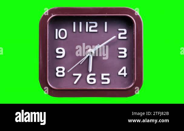 Timelapse of analog clock with spinning watch hands on a green ...