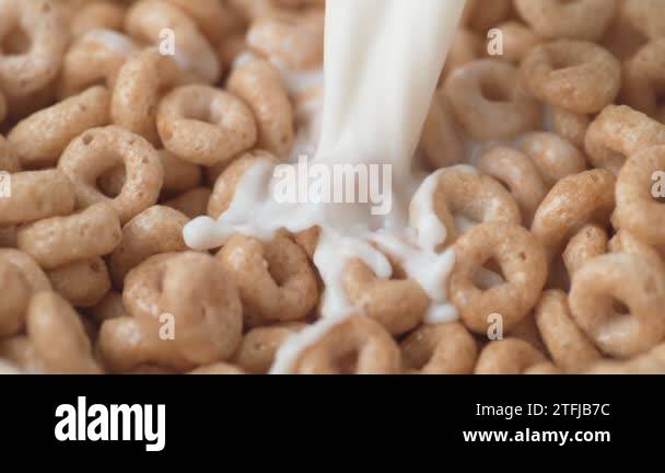 Pouring milk into cereal Stock Video Footage - Alamy