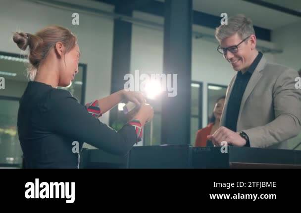 Businessman in international airport at check-in counter checking staff ...