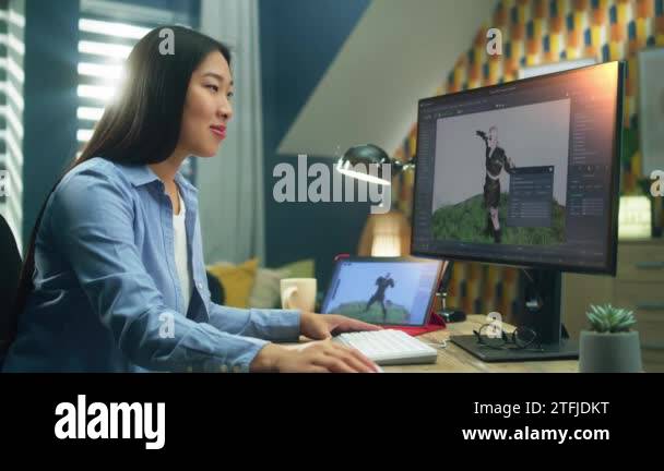 Asian female 3D designer making animation for video game character ...