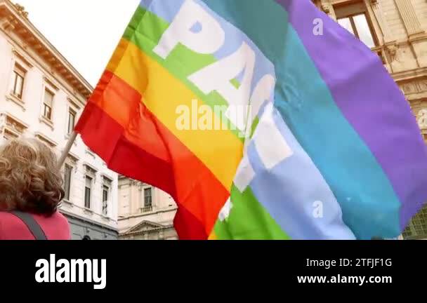 People with peace rainbow flags waving in slow motion at a ...