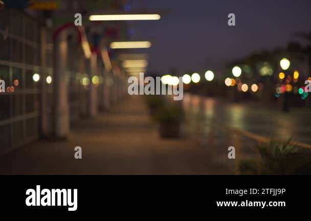 Out of focus background plate of downtown city boardwalk at night with ...