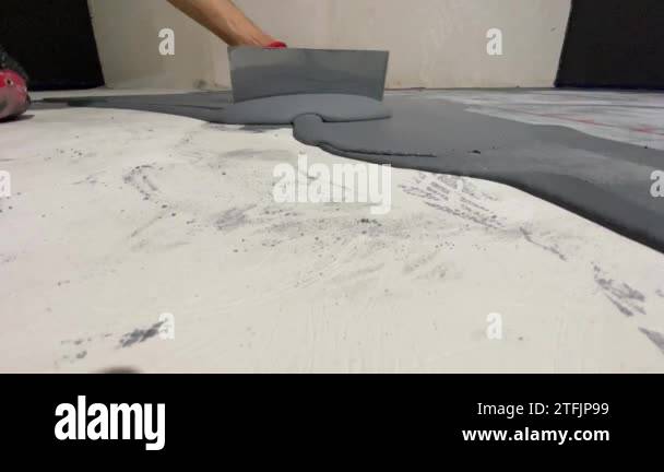 Applying a decorative microcement coating to the floor Stock Video ...