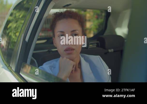 Portrait of beautiful relaxed black female passenger sitting in car ...