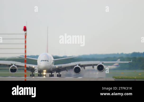 Widebody aircraft braking after landing, front view. Cinematic footage ...