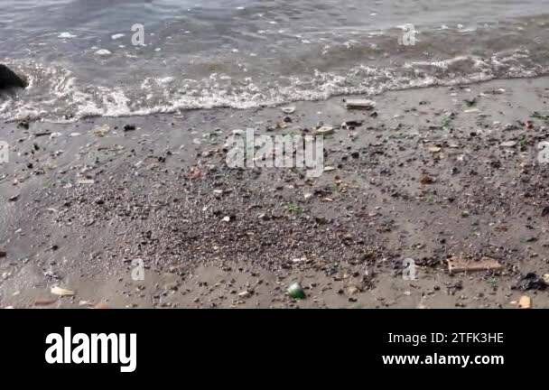 Littered beach in USA. Atlantic Ocean pollution, sandy beach covered by ...