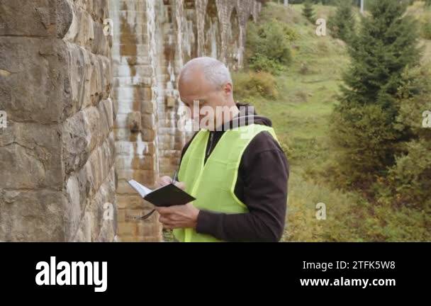 Senior male engineer to restore ancient buildings or bridges ...