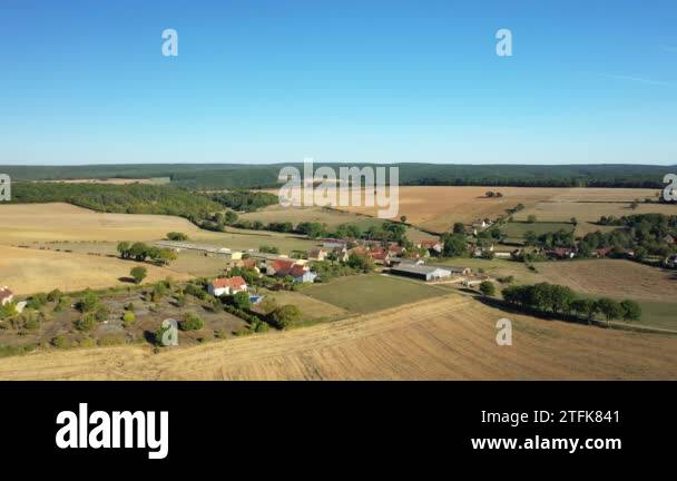 A traditional village in the green countryside with fields after ...