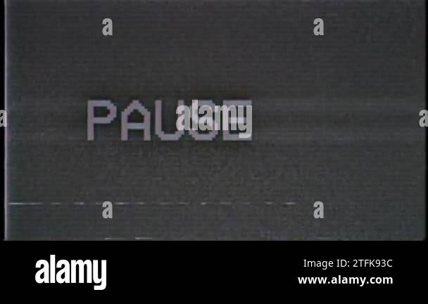 Old damaged VHS tape playing with PAUSE text message on screen, retro ...