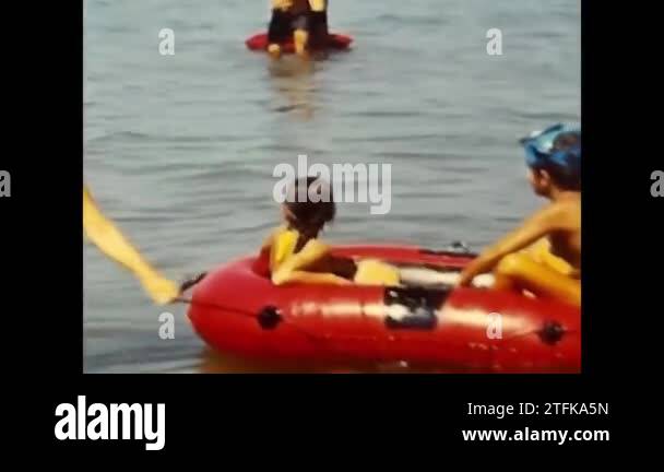 Lavinio , italy June 1970 : Children at the sea of Lavinio in the red ...