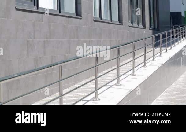 A ramp with stainless steel handrails for wheelchairs, bicycles and ...