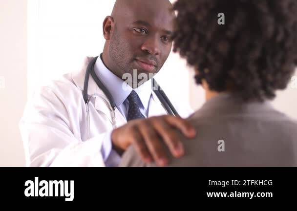 Black doctor talking to patient Stock Video Footage - Alamy