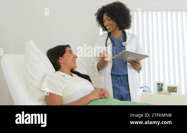 Female multiracial doctor and patient talking to each other Stock Video ...