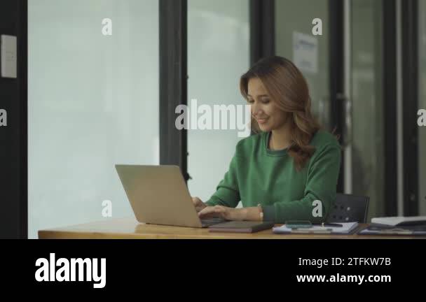 Beautiful and smart Asian woman with a happy mood and smile using a ...