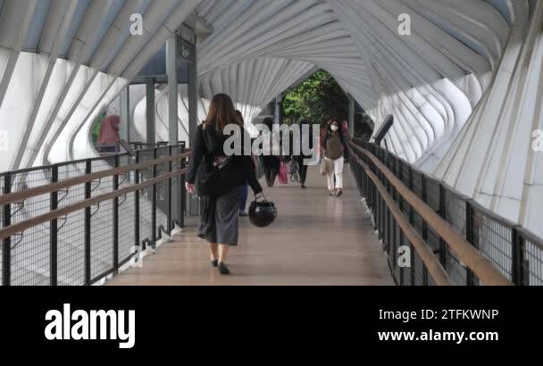 Indonesia - April 11, 2022: Pedestrians walk on the pedestrian bridge ...