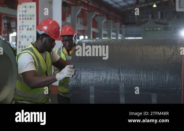 Two black workers engineer factory textile inspection and checking ...