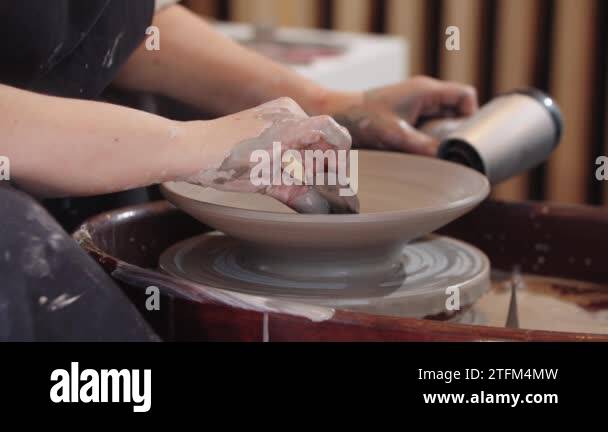 Heating the clay plate on the pottery wheel using a hairdryer and ...