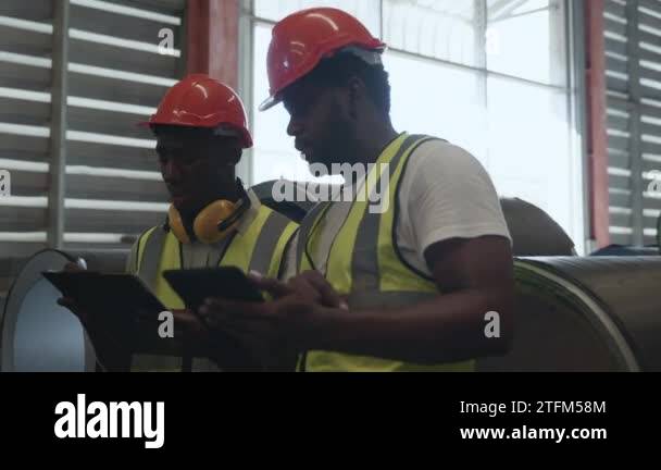 Engineer two worker man African black marking inspection on roll metal ...