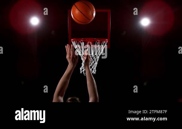 Super slow motion of basketball player hitting the basket. Filmed on ...