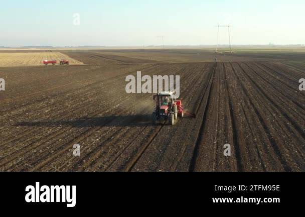 Above dolly move, flying over in backwards, tractor is pulling seed ...