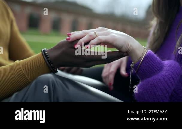 Young interracial couple hands and arms caress and affection together ...