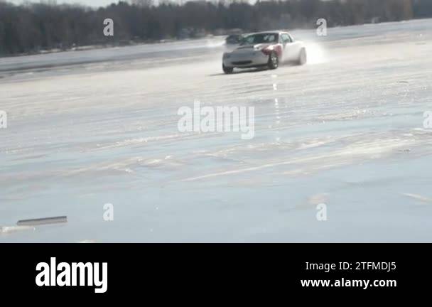shot of white red car drifting on a snow winter track. A lot of snow 4k ...