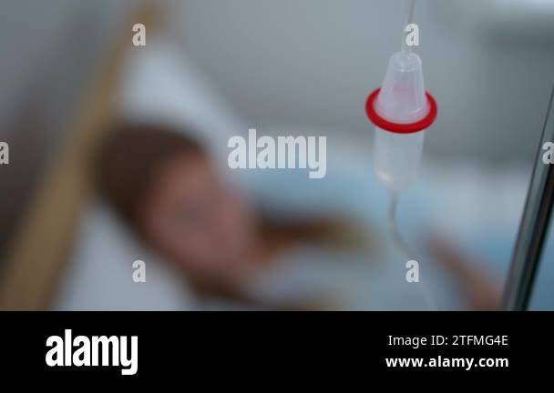 Close-up medical dropper in hospital ward with blurred Caucasian ...