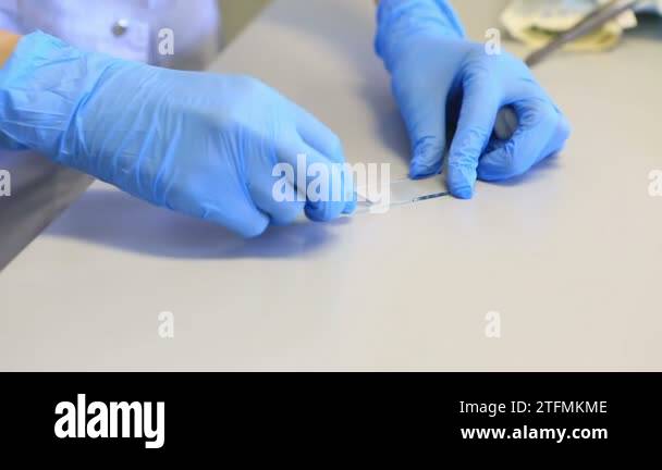 Preparation of smear. Applying a drop of blood on glass slide, and the ...