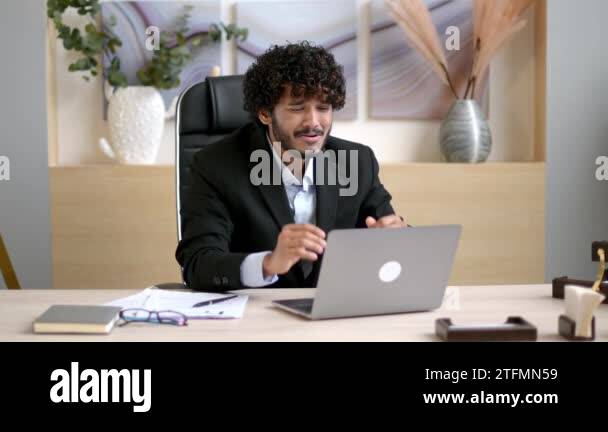 Irritated arabian or indian businessman, ceo or manager, sitting in a ...