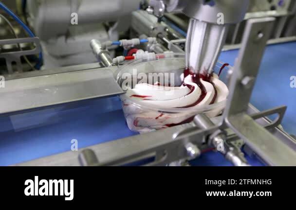 Industrial robot making ice cream. Ice cream production. Automated ...