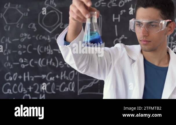 arabic test tube laboratory assistant. a wide flask in the hands of a ...