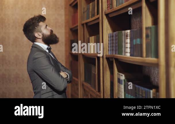 Concentrated man in the old library. Classic vintage interior. Law and ...