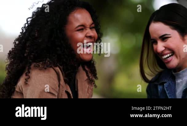 Two friends laughing together, Candid diverse young women real life ...