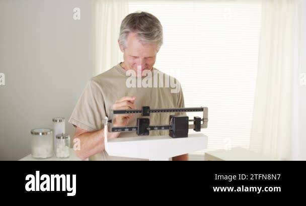 Happy man scale Stock Videos & Footage - HD and 4K Video Clips - Alamy