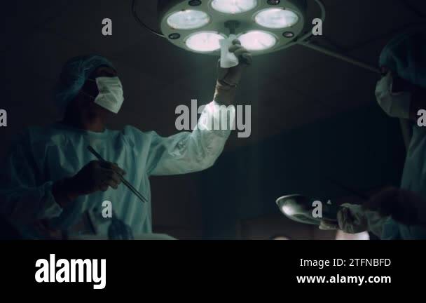 Doctor adjusting surgery lights in operating room. Hospital intensive ...