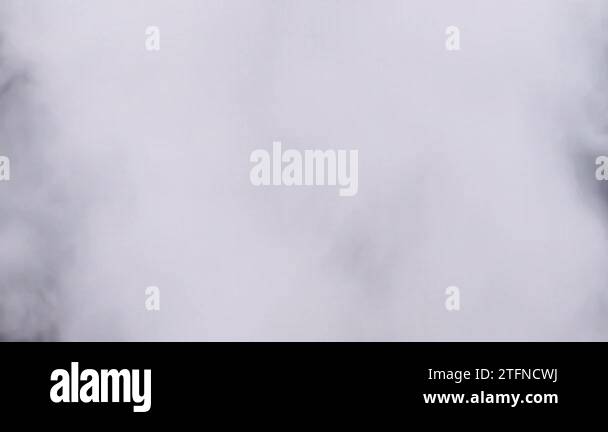 White smoke on black background. A cloud of vapor steam rises up ...