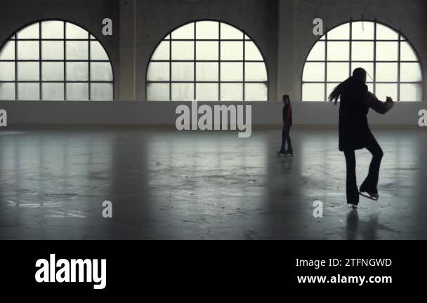 Woman coach shows her girl student elements of figure skating ...