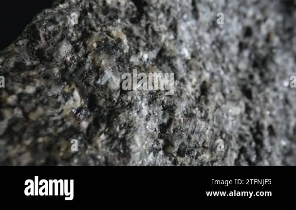 Background of natural stone texture of gray rough granite. A piece of ...