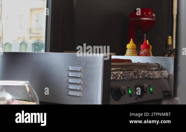 Closing and heating sausages in a rolling machine. Rolling hot sausages ...