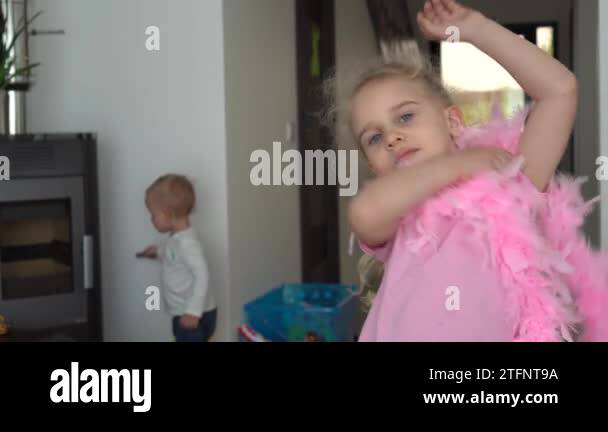 Sister child pose with pink feather shawl and brother boy play. Gimbal ...