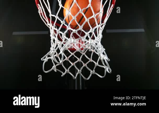 Super slow motion of basketball ball hitting the basket. Filmed on high ...