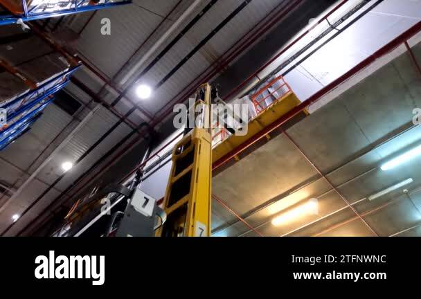 Two level warehouse. The forklift picks up a pallet from the second ...